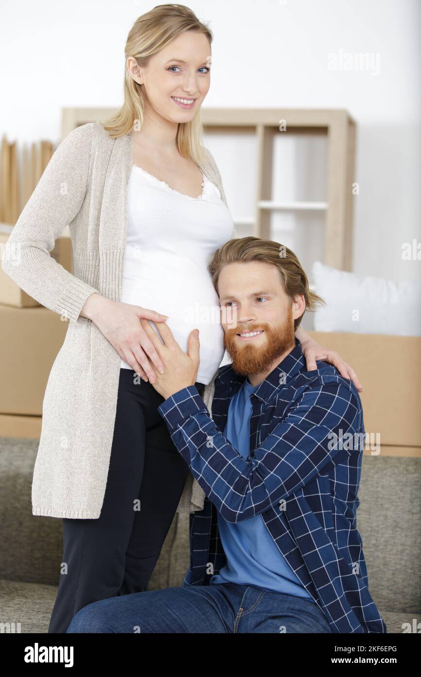 handsome man is listening to his beautiful pregnant wife Stock Photo ...