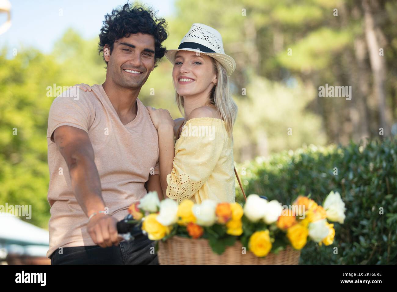 happy funny young couple riding on bicycle Stock Photo - Alamy