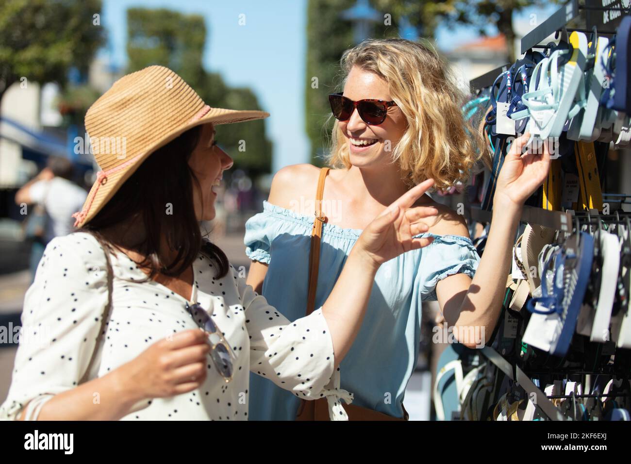 women browsing a rail of clothes at a street market Stock Photo - Alamy