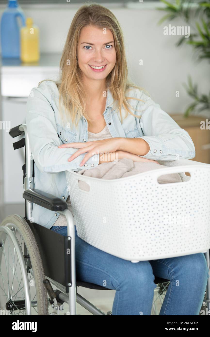 young disabled woman on wheelchair doing laundry Stock Photo - Alamy