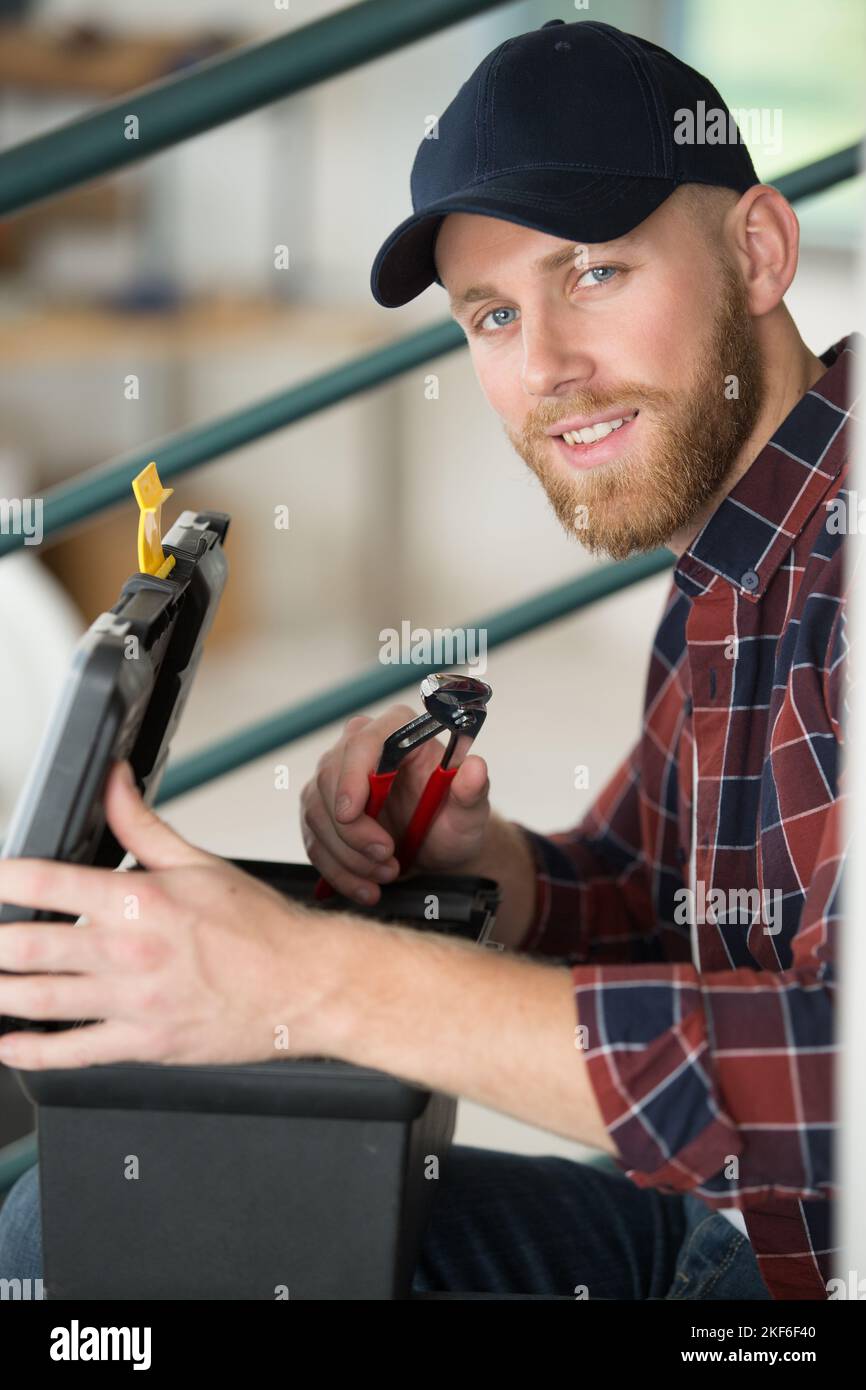 man smiles with holding the tool box Stock Photo - Alamy