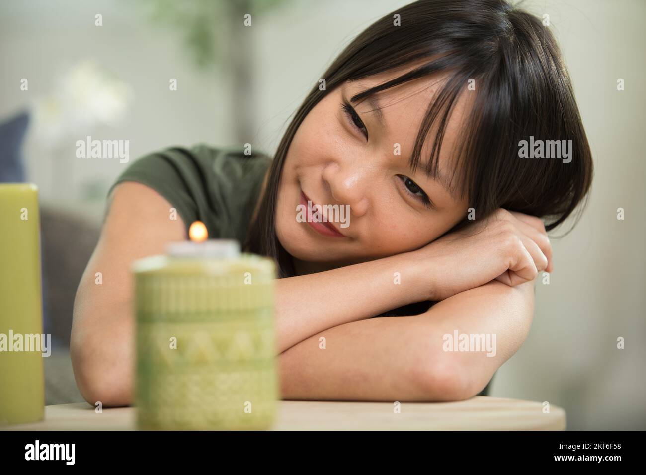 happy woman next to a candle Stock Photo - Alamy