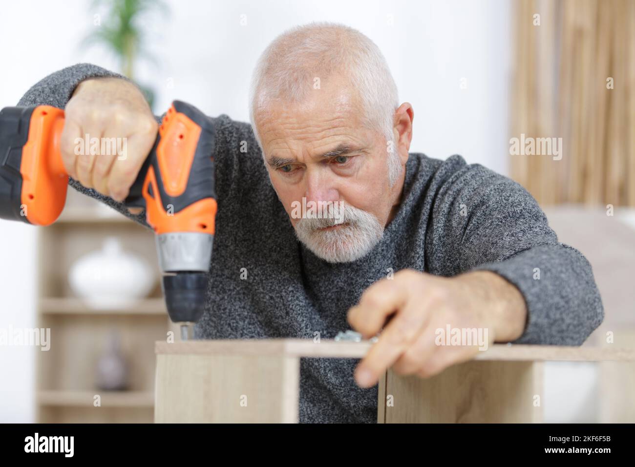 Old man drilling furniture drill hi-res stock photography and images ...