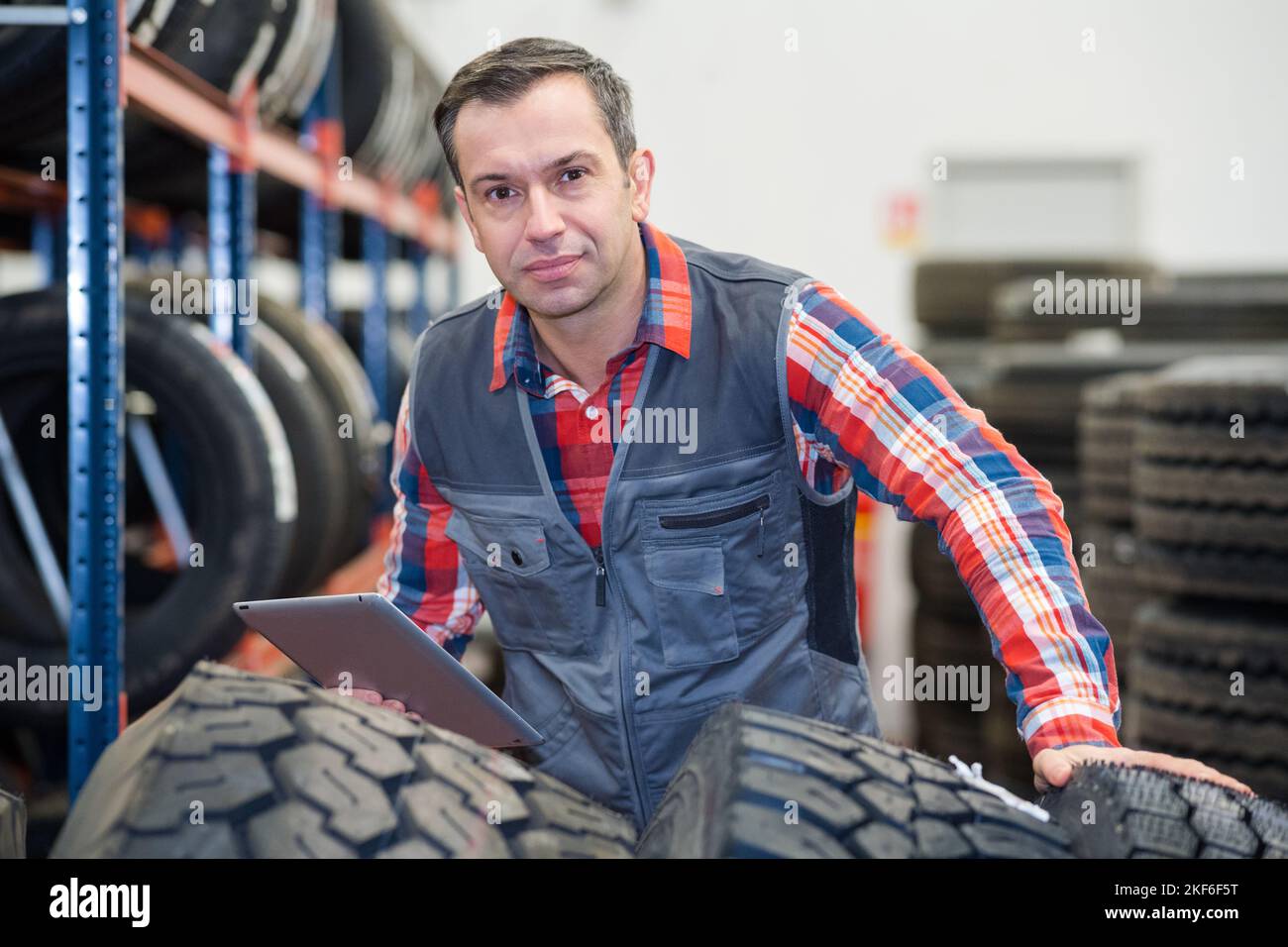 vulcanizing shop worker holding clipboard Stock Photo - Alamy