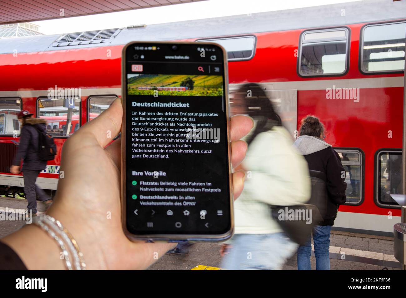 Symbol image Deutschlandticket, 49-Euro-Ticket: Close-up of a smartphone in front of passengers ...