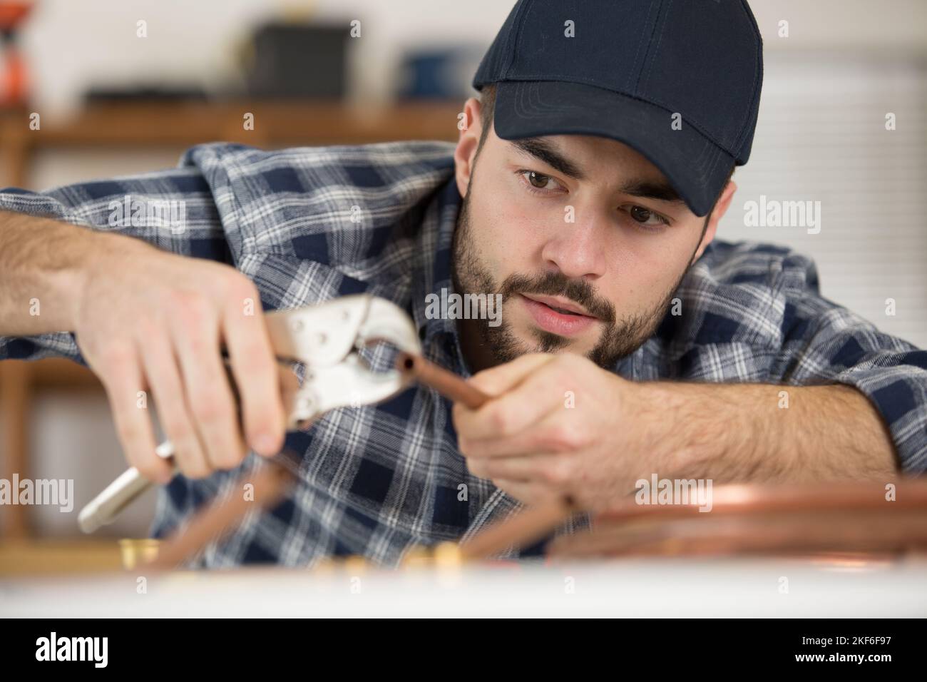 craftsman cutting a cooper cable Stock Photo - Alamy
