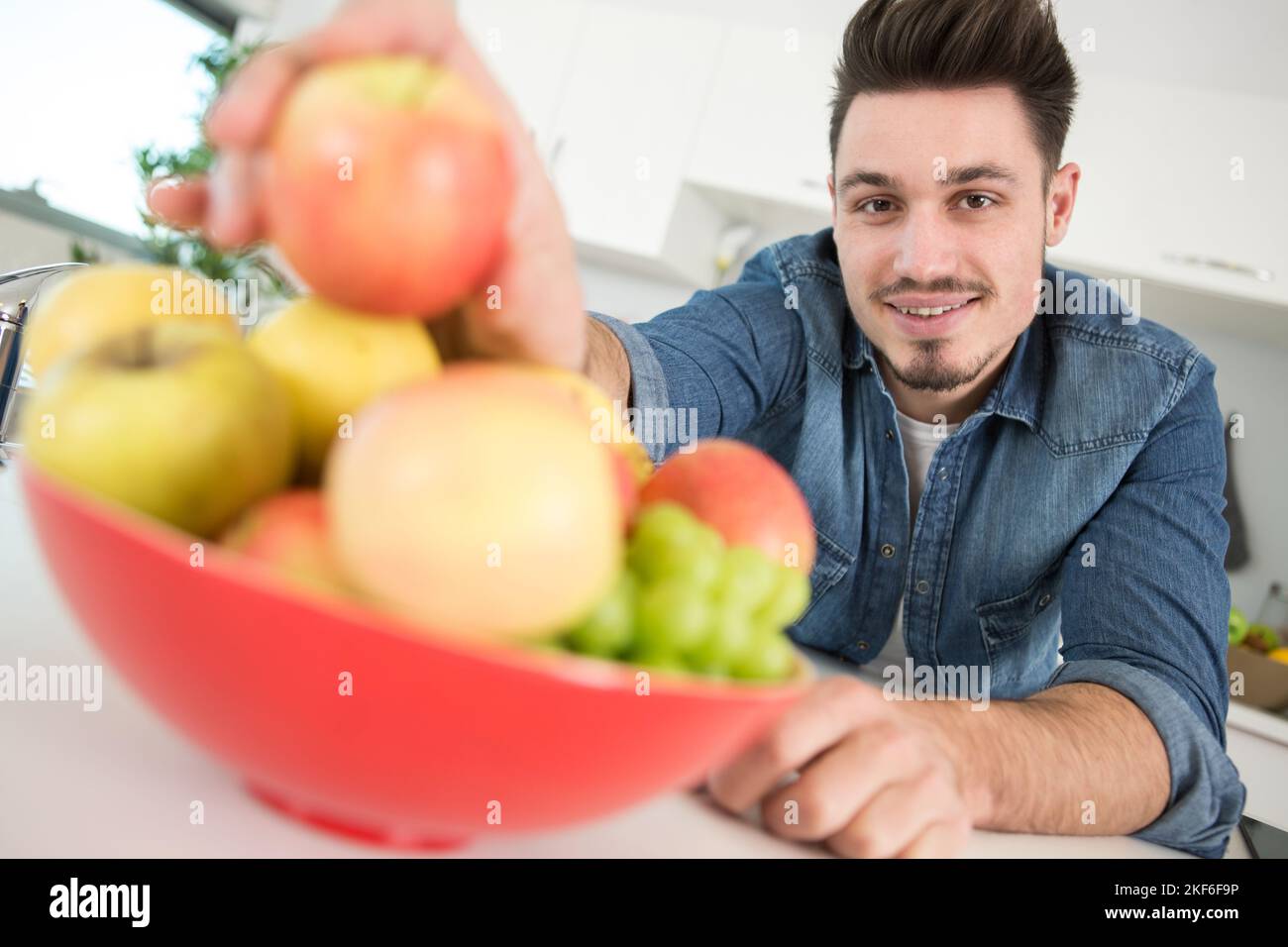 man with fruits in his kitchen Stock Photo - Alamy