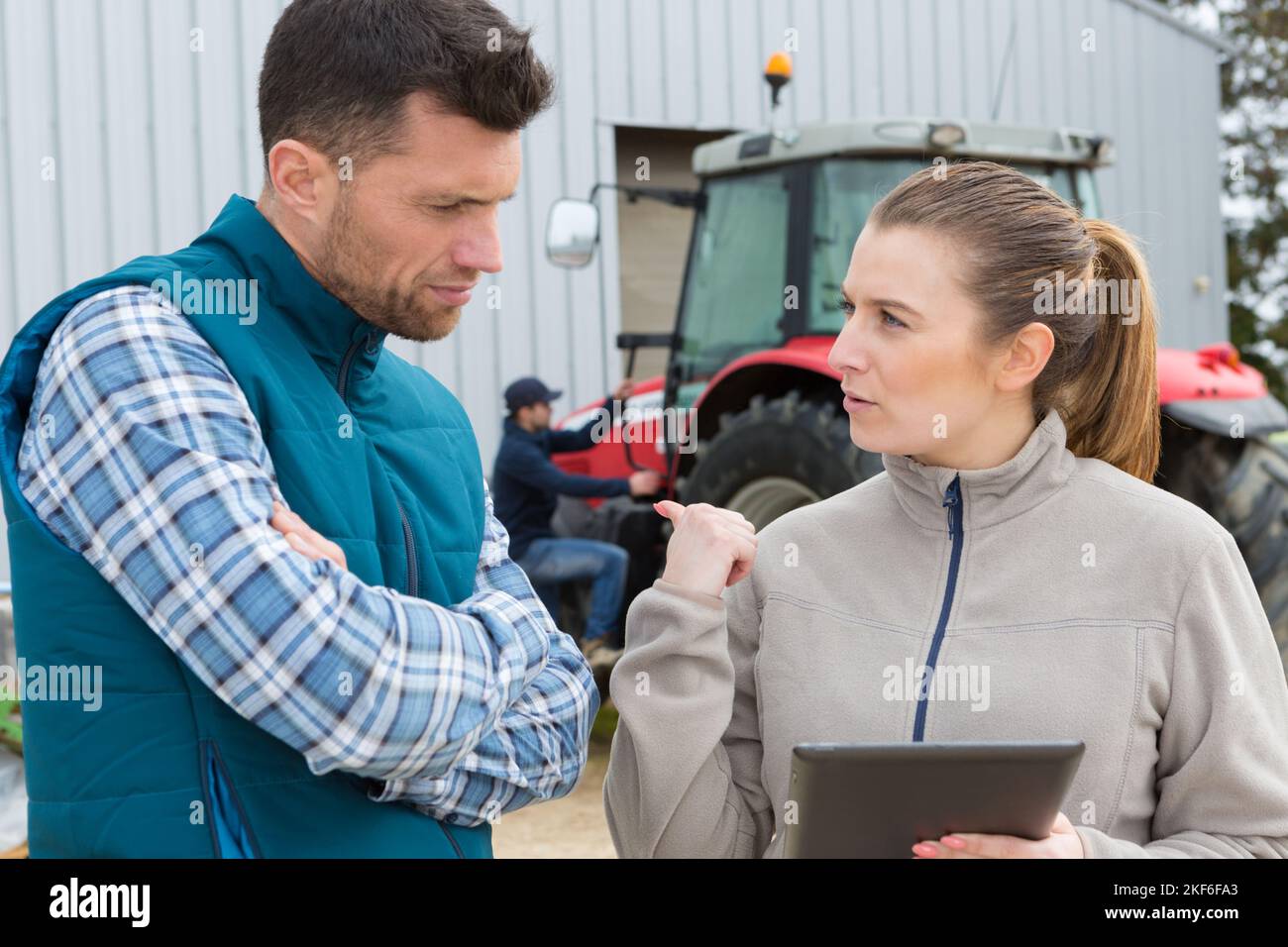 farmer and woman with clipboard talking on dairy farm Stock Photo - Alamy