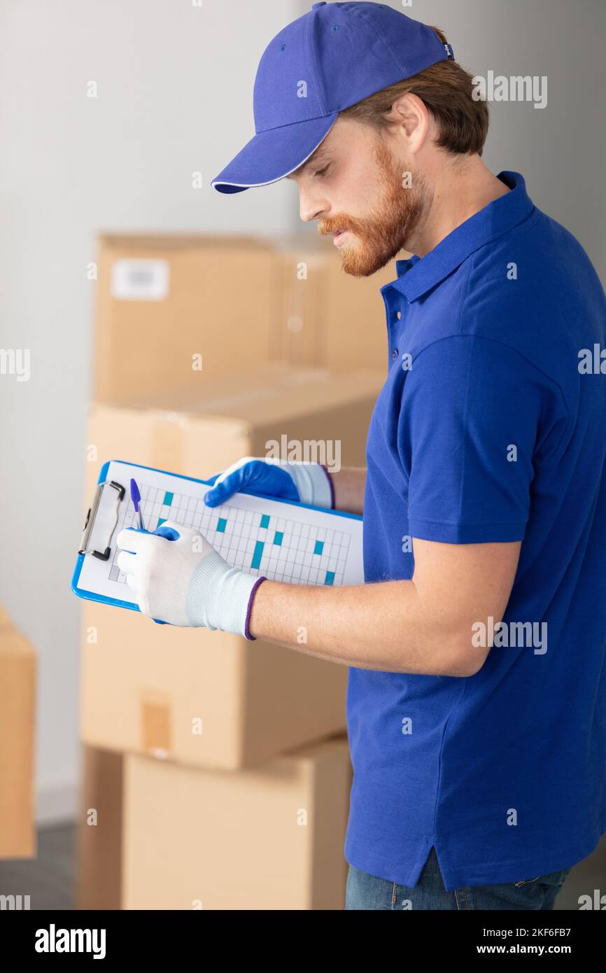 Delivery man in blue uniform hi-res stock photography and images - Alamy