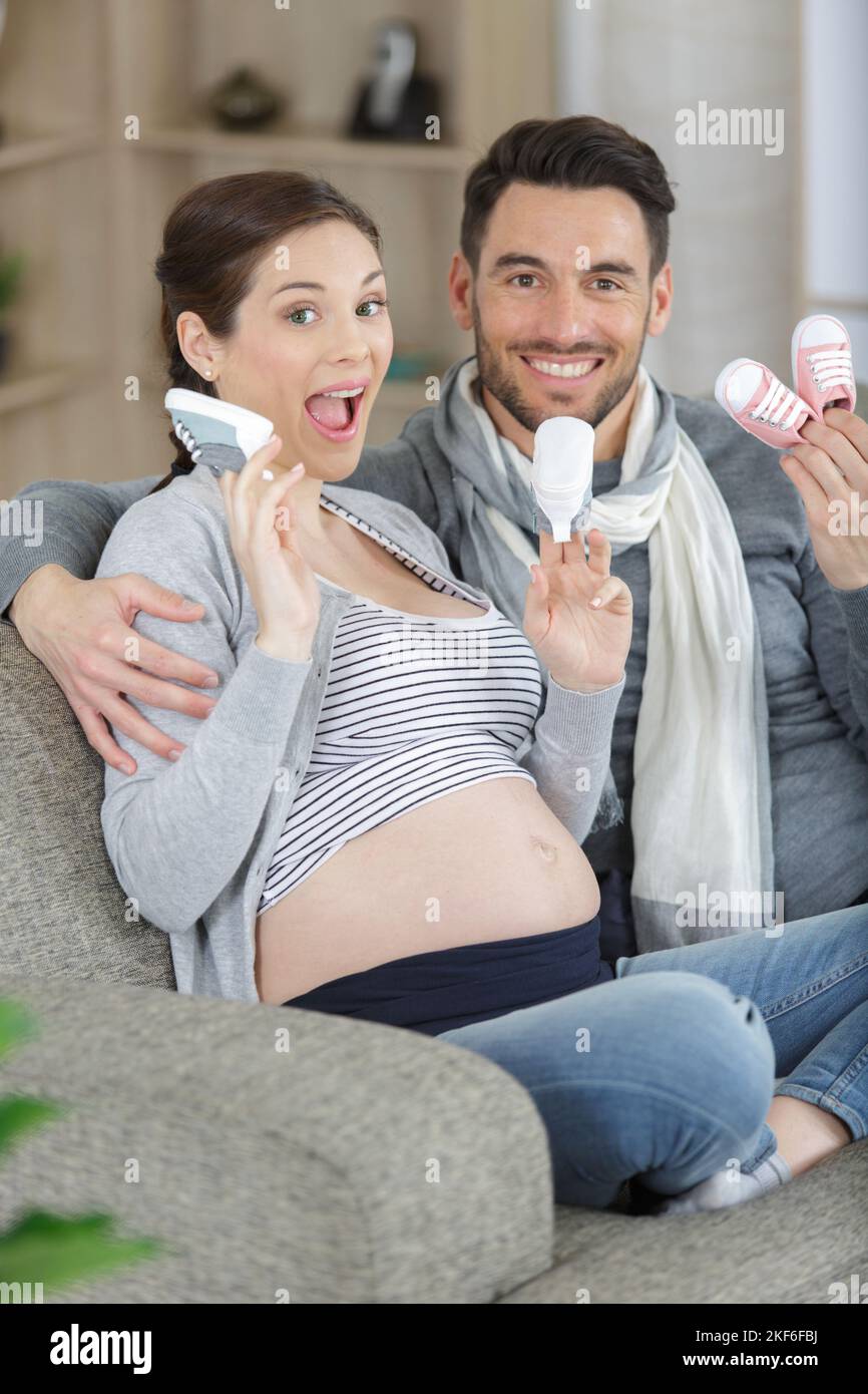 future parents holding little shoes at the camera Stock Photo - Alamy