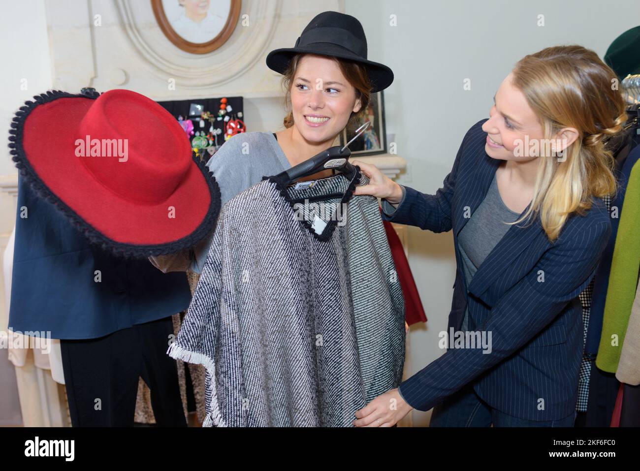 Young woman taking clothes try hi-res stock photography and images - Alamy