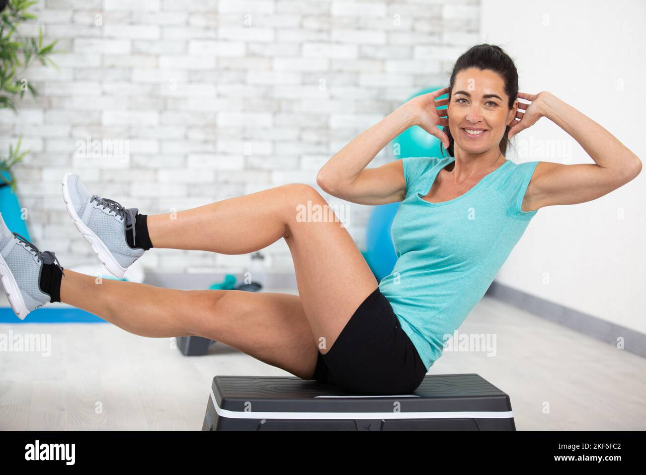 beauty woman make abs exercise on step Stock Photo - Alamy