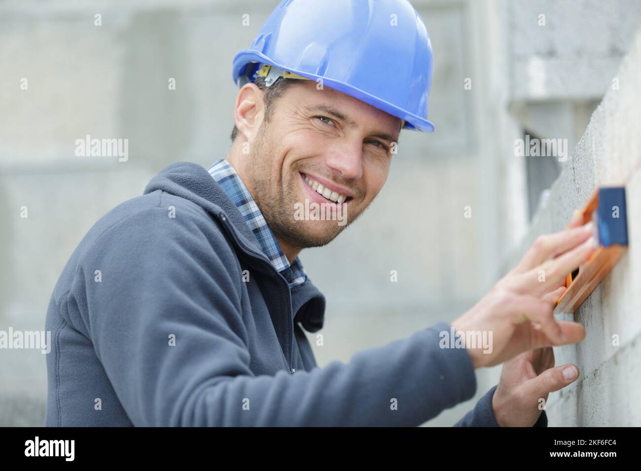 masonry construction worker levels the wall Stock Photo - Alamy