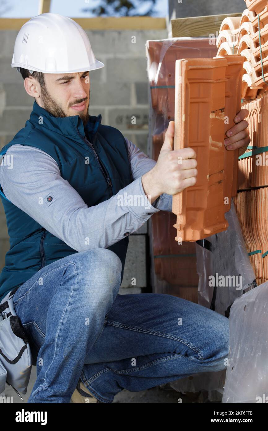 Man laying paving tiles hi-res stock photography and images - Alamy