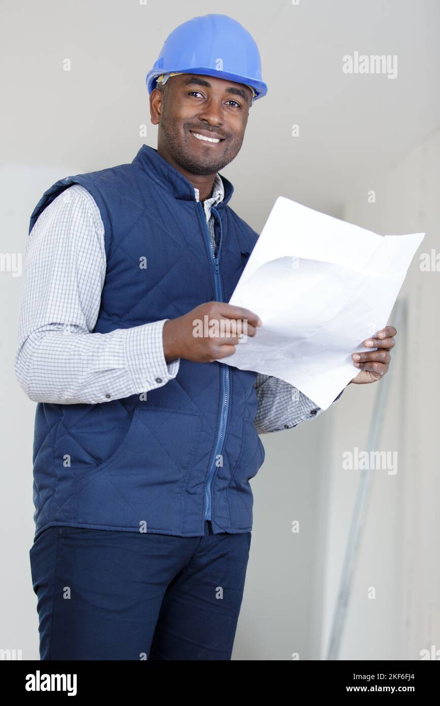 contractor holding blueprints inside home construction site Stock Photo ...