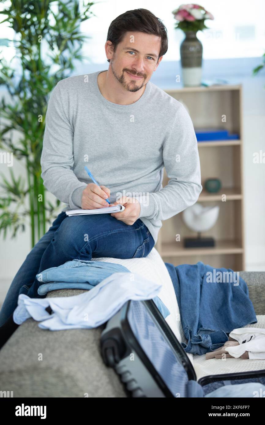 Man packing laptop bag hi-res stock photography and images - Alamy