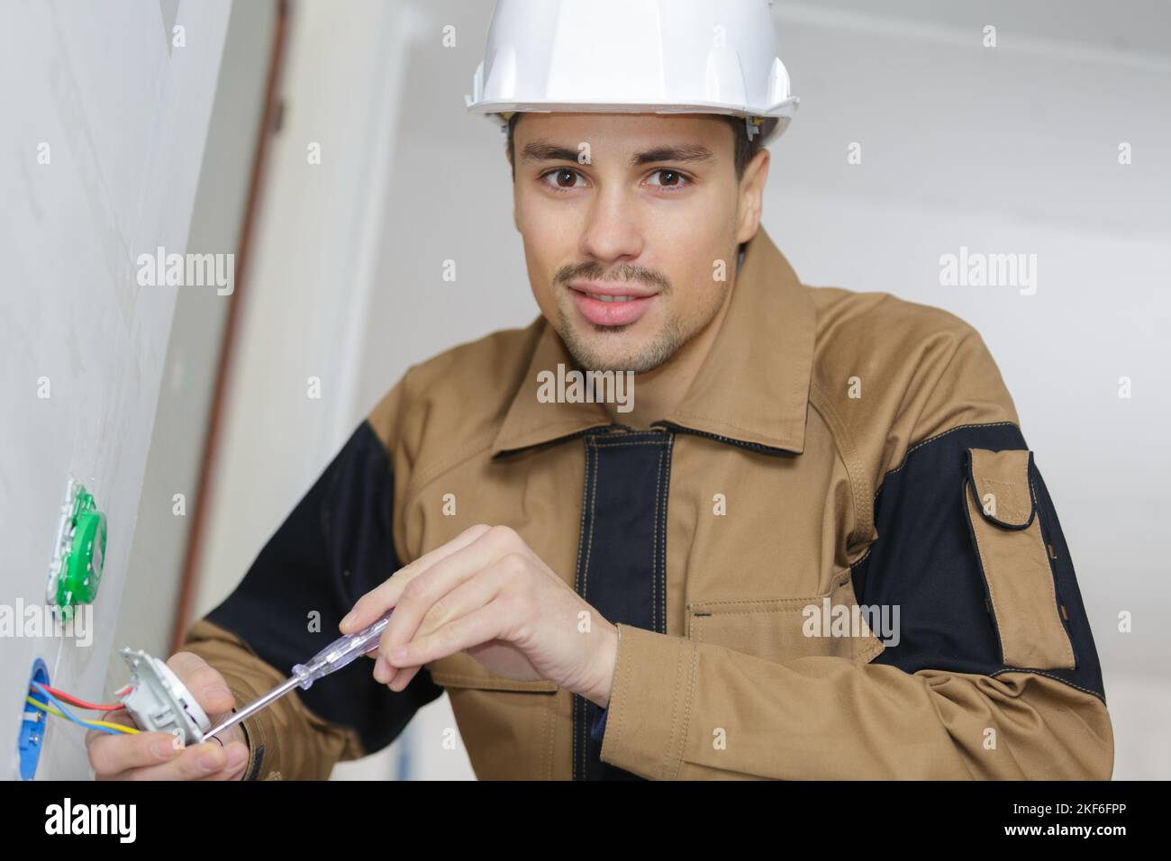 electrician mending wall plug Stock Photo - Alamy