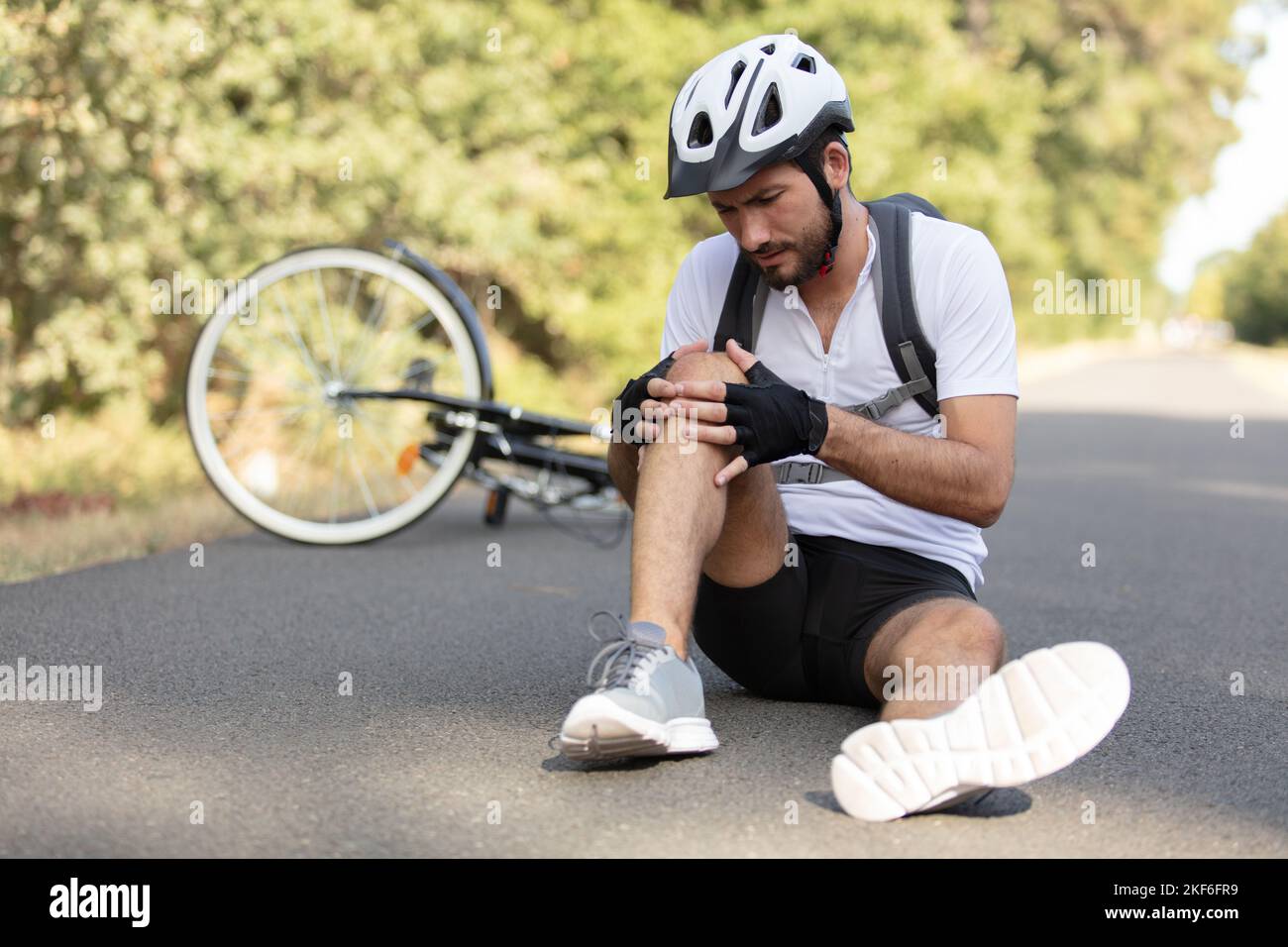 man cyclist fell fell off road bike while cycling Stock Photo - Alamy