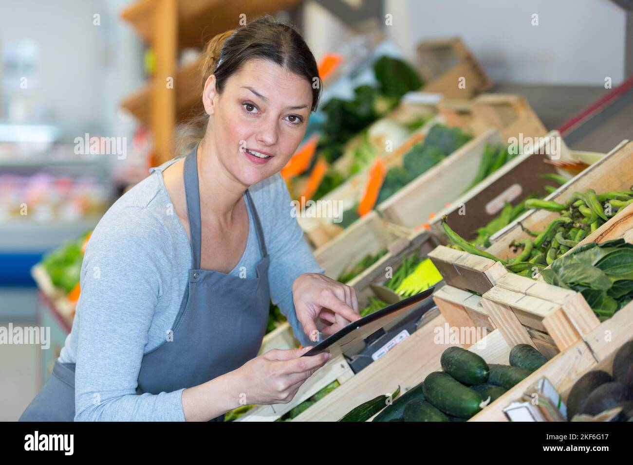 grocery store worker with surprised expression using tablet Stock Photo ...