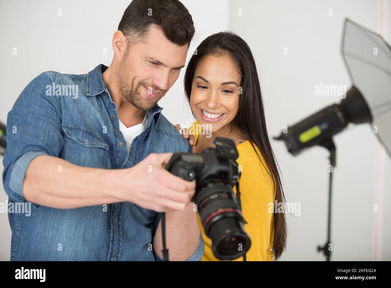 photographer and model reviewing photos on camera screen Stock Photo ...