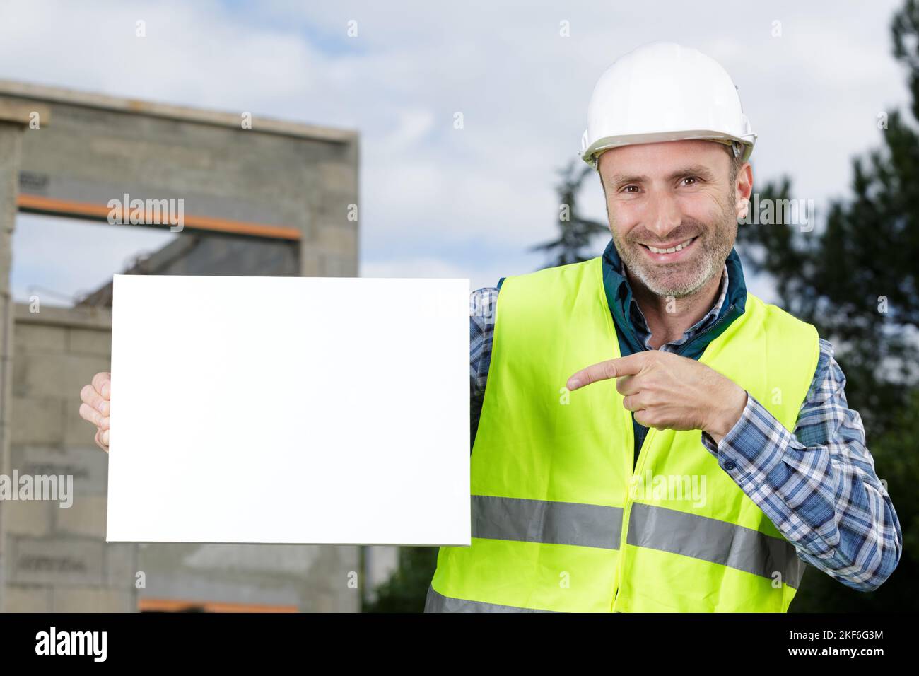 happy worker presenting empty banner Stock Photo - Alamy
