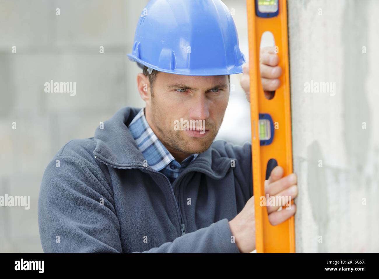 concentrated man measuring voltage wall Stock Photo - Alamy