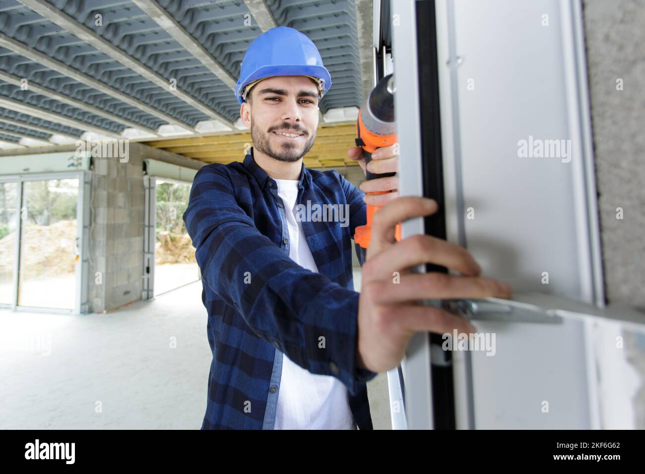young male builder using power tool Stock Photo - Alamy