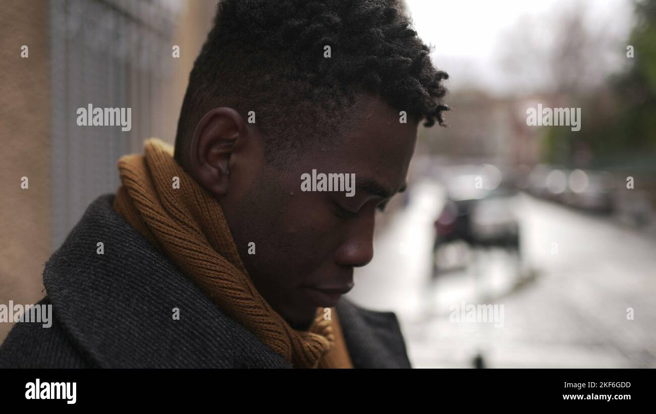 Concerned african man thinking in hi-res stock photography and images ...