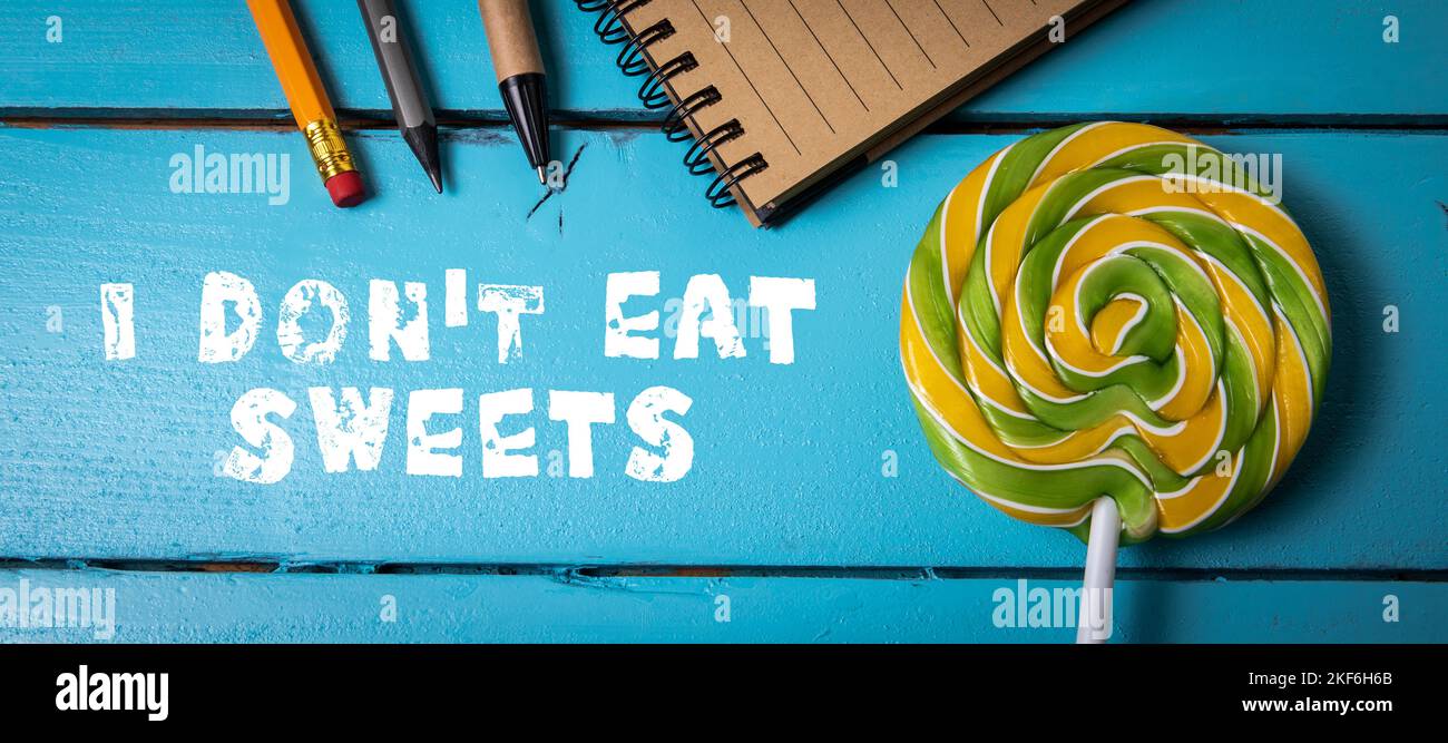 I don't eat sweets. Colorful lollipop on blue wooden office table Stock ...