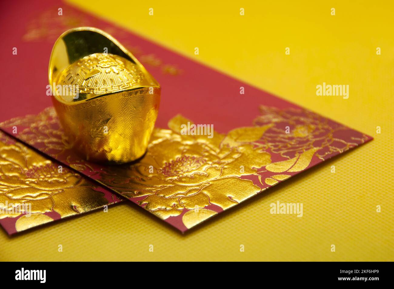 Chinese New Year packets with Chinese Gold Ingots on yellow background ...