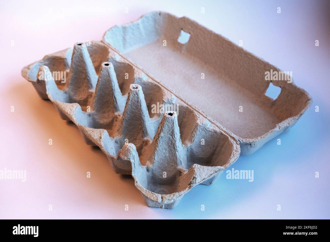 Opened egg carton with ten eggs isolated on white background. Recycled ...