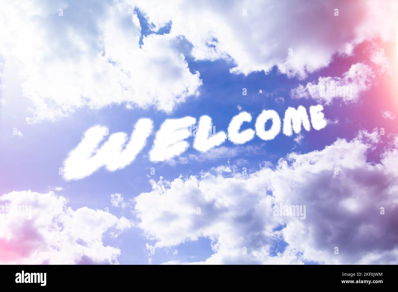 Welcome. Text from clouds in sky in bright sunlight Stock Photo - Alamy