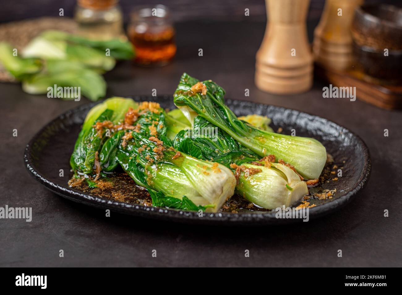 A closeup of deliciously cooked bok choy on a plate on the table ...