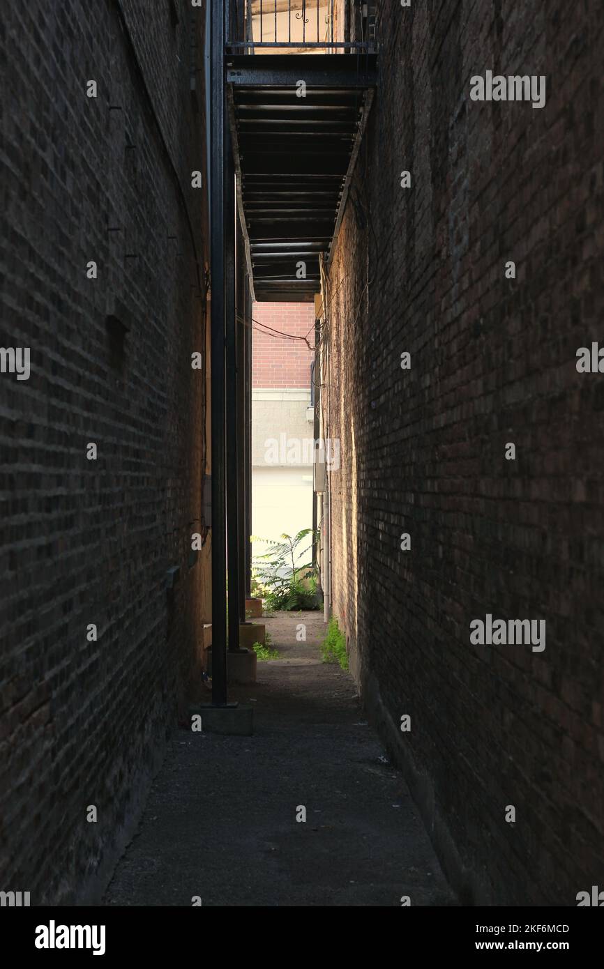 A typical common back alley between two urban buildings Stock Photo - Alamy