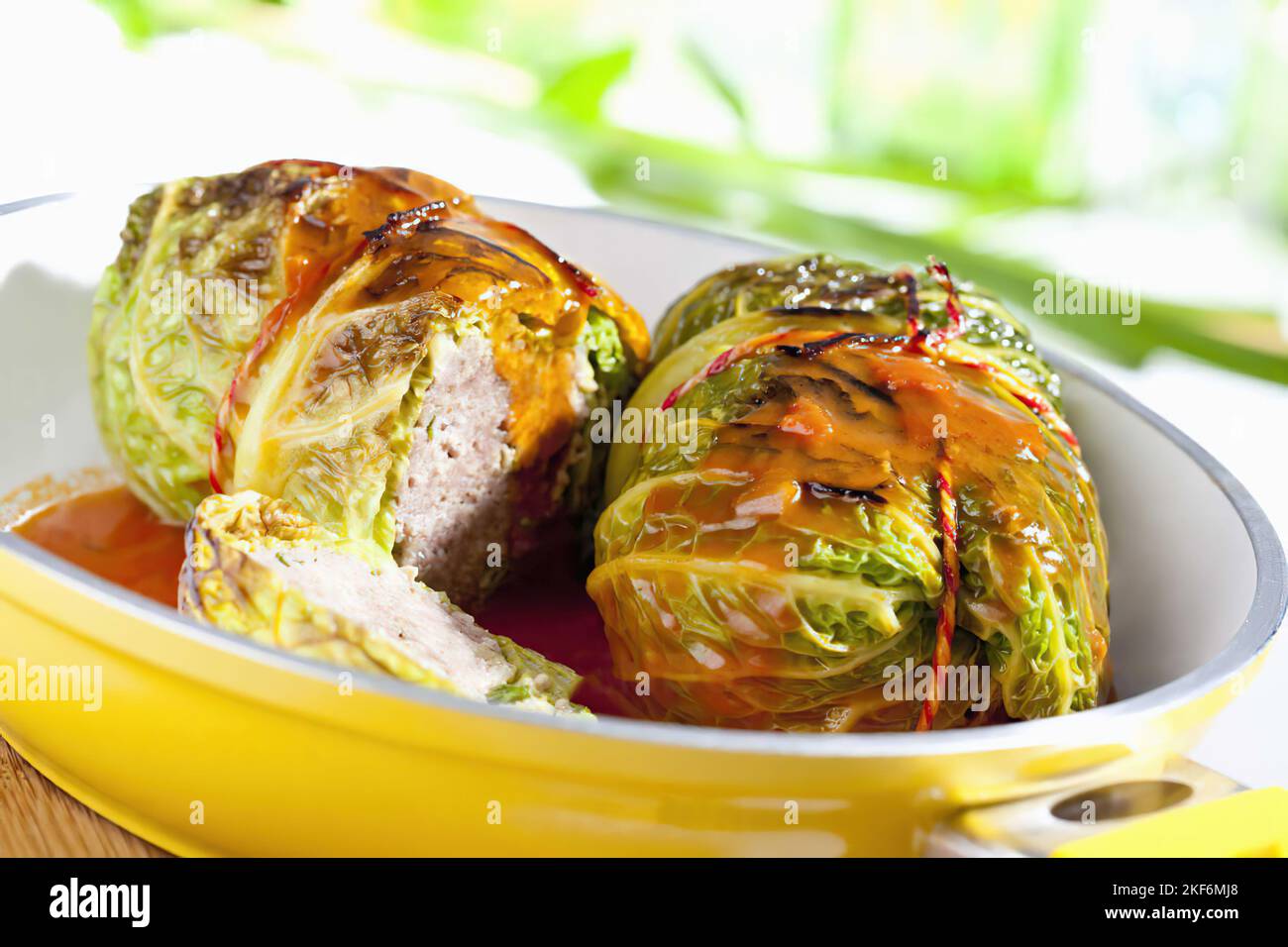 Stuffed savoy cabbages with tomato sauce in pan Stock Photo - Alamy
