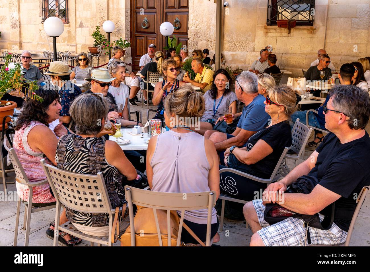 A Group Of People Chatting Outside A Cafe In Piazza Duomo, Ortigia ...