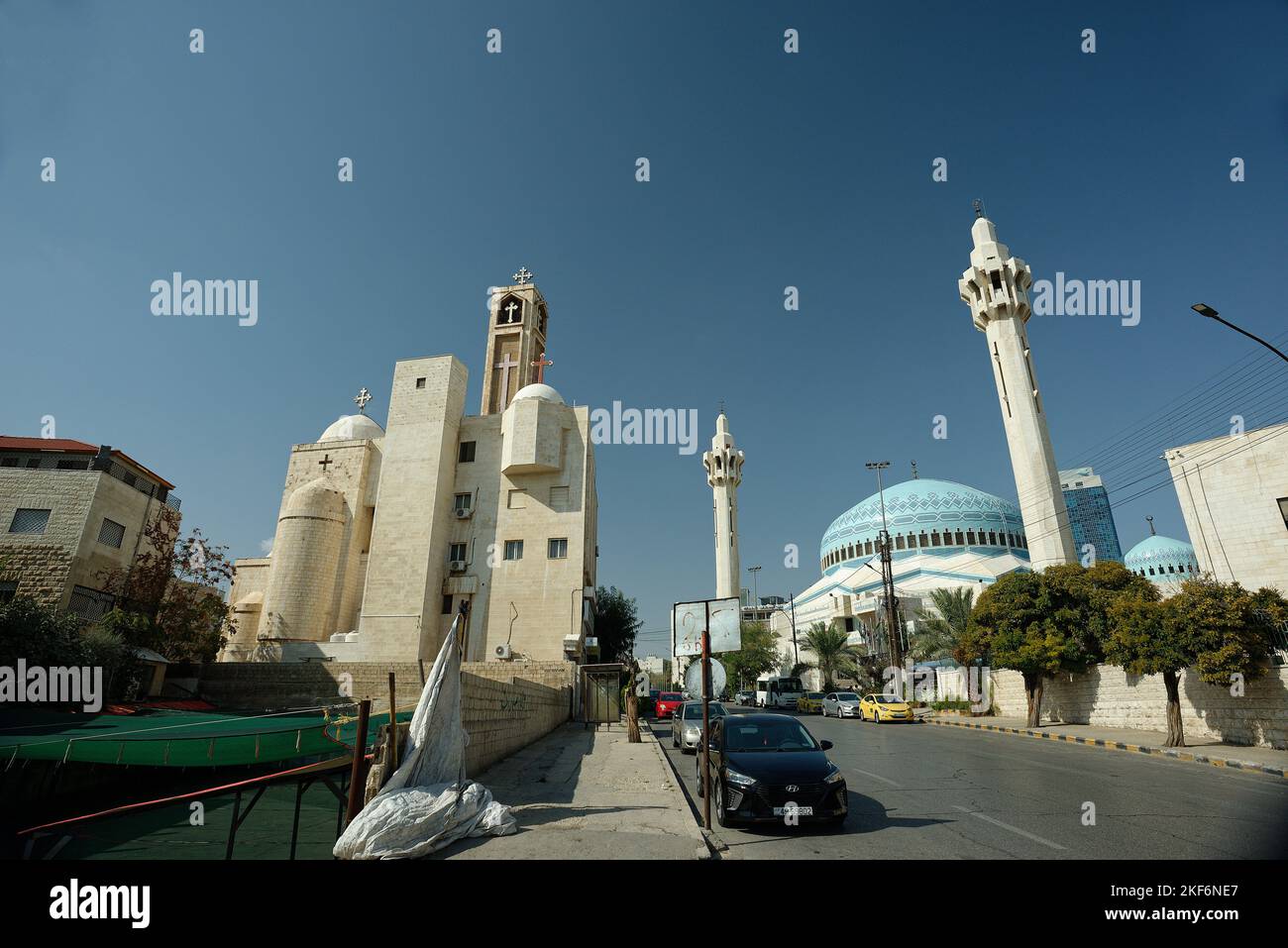 A Christian church and a modern Islamic mosque next to each other in ...
