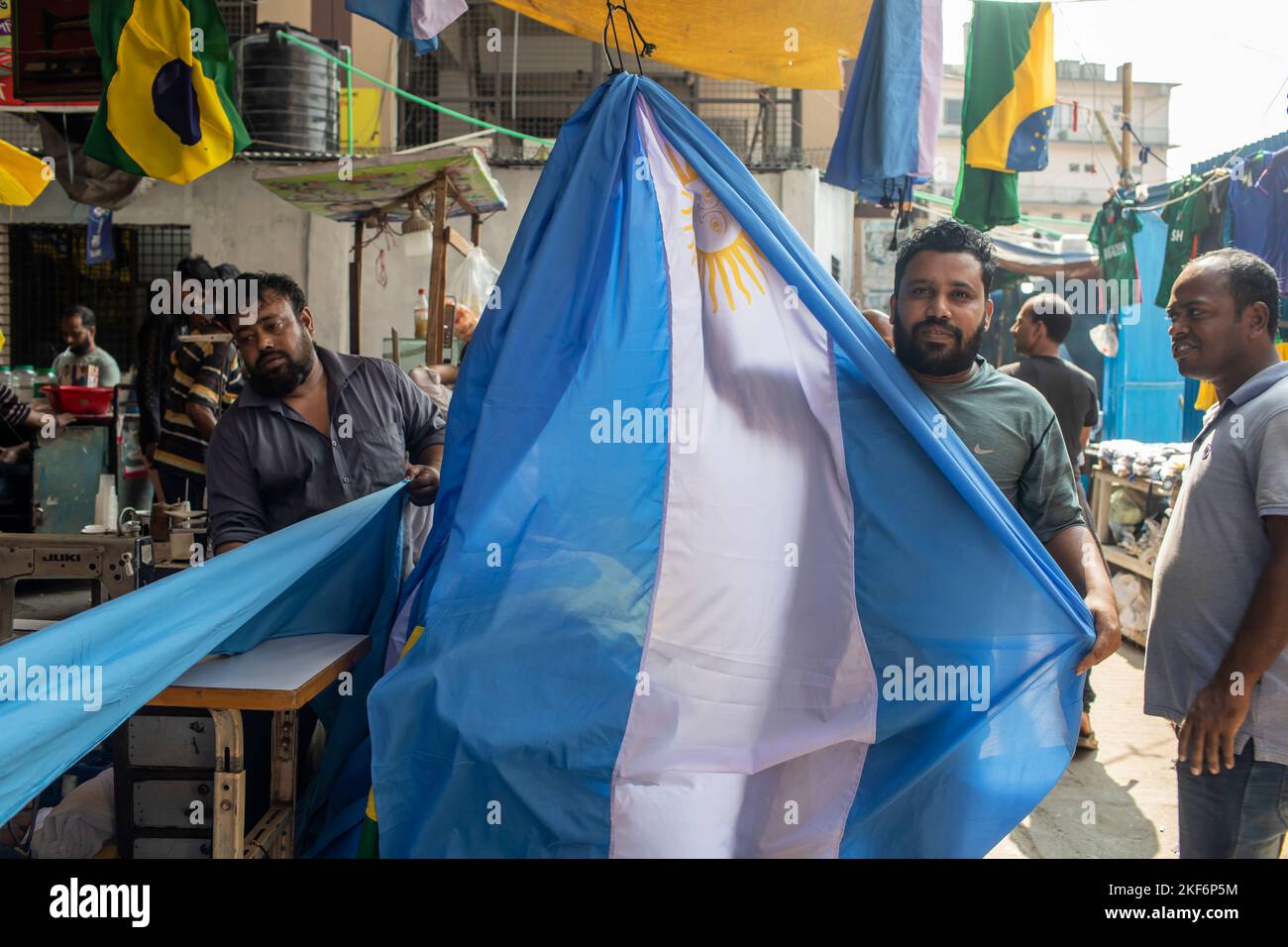 A Bangladeshi vendor seen sewing a flag of Argentina a participating ...