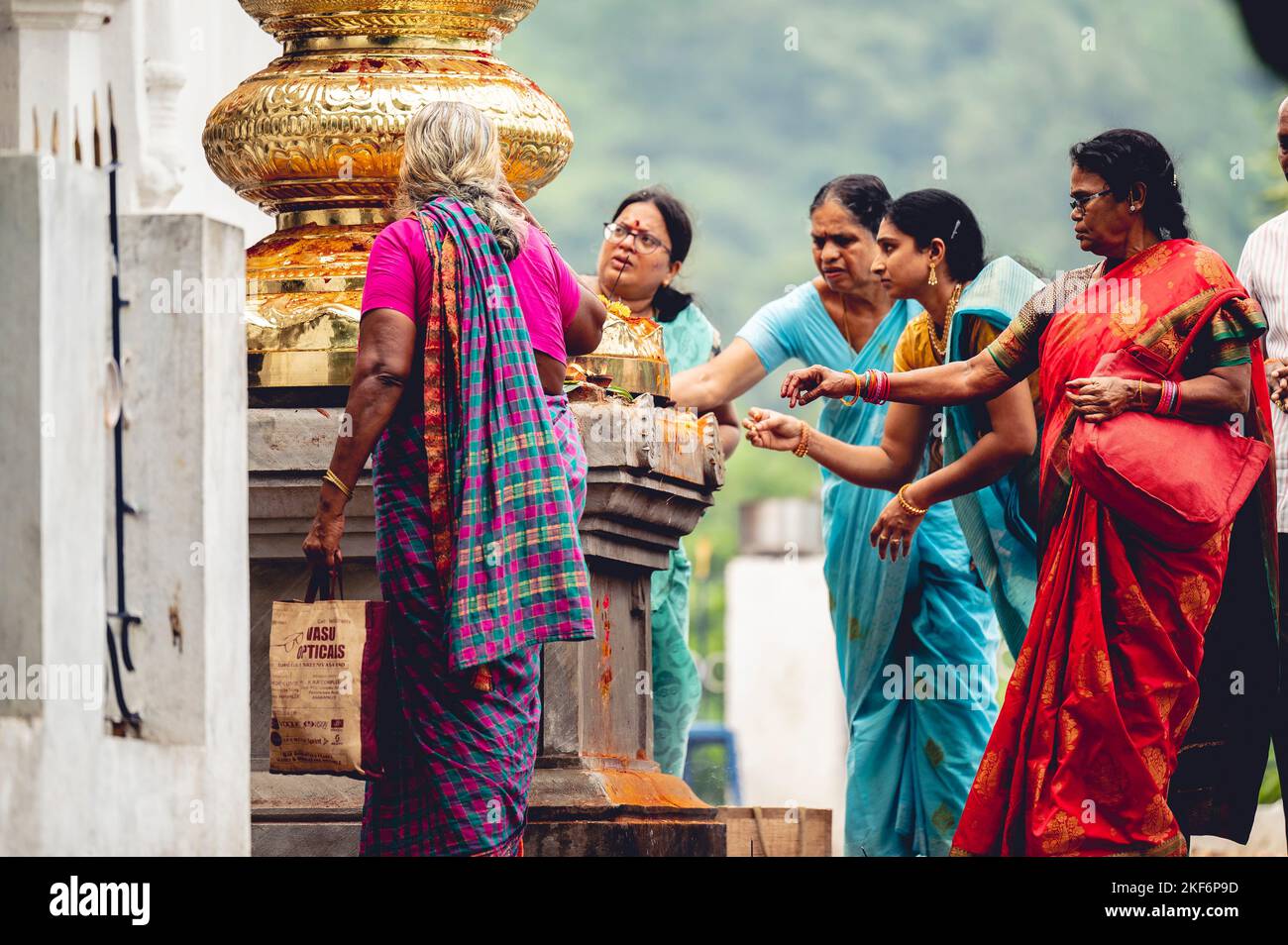 The women praying to idols and guards at the Narasimha Hindu temple in ...