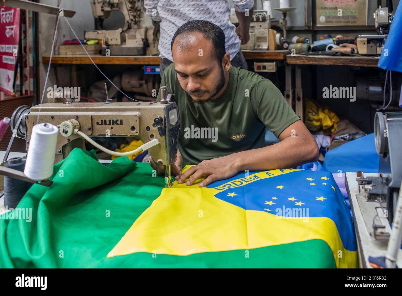A Bangladeshi vendor seen sewing a flag of Brazil a participating ...
