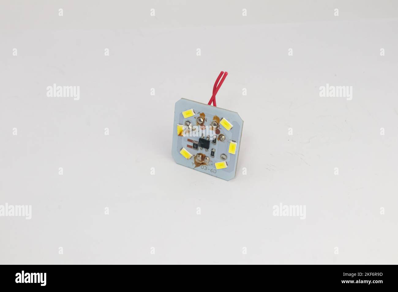 A PCB of a white LED light with a resistor and a Power IC on a white ...