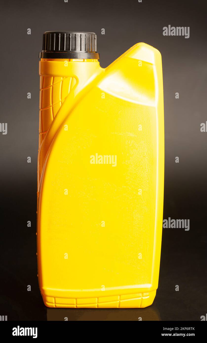 yellow engine oil bottle on black Stock Photo - Alamy