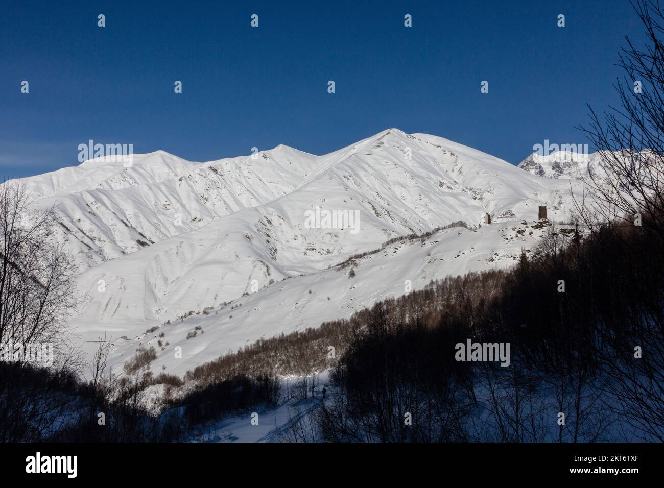 Svan towers in front of Mount Shkhara is a nine summit mountain, one of ...