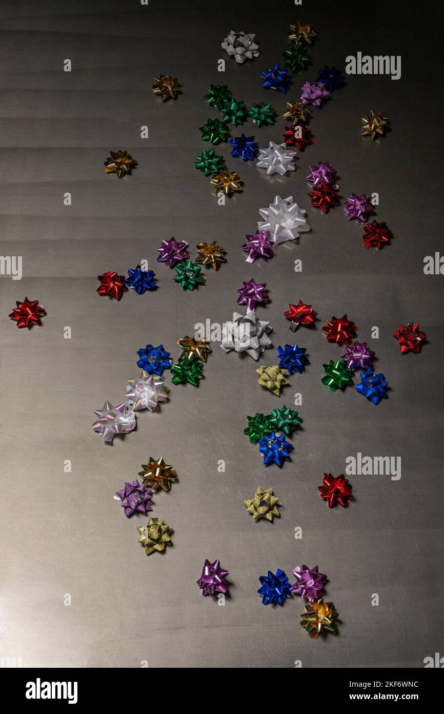 Bold bright colored wrapping paper stars forming patterns on a shiny ...