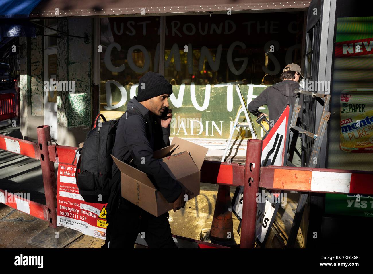 Members of the public walk between barriers during works disruption of ...