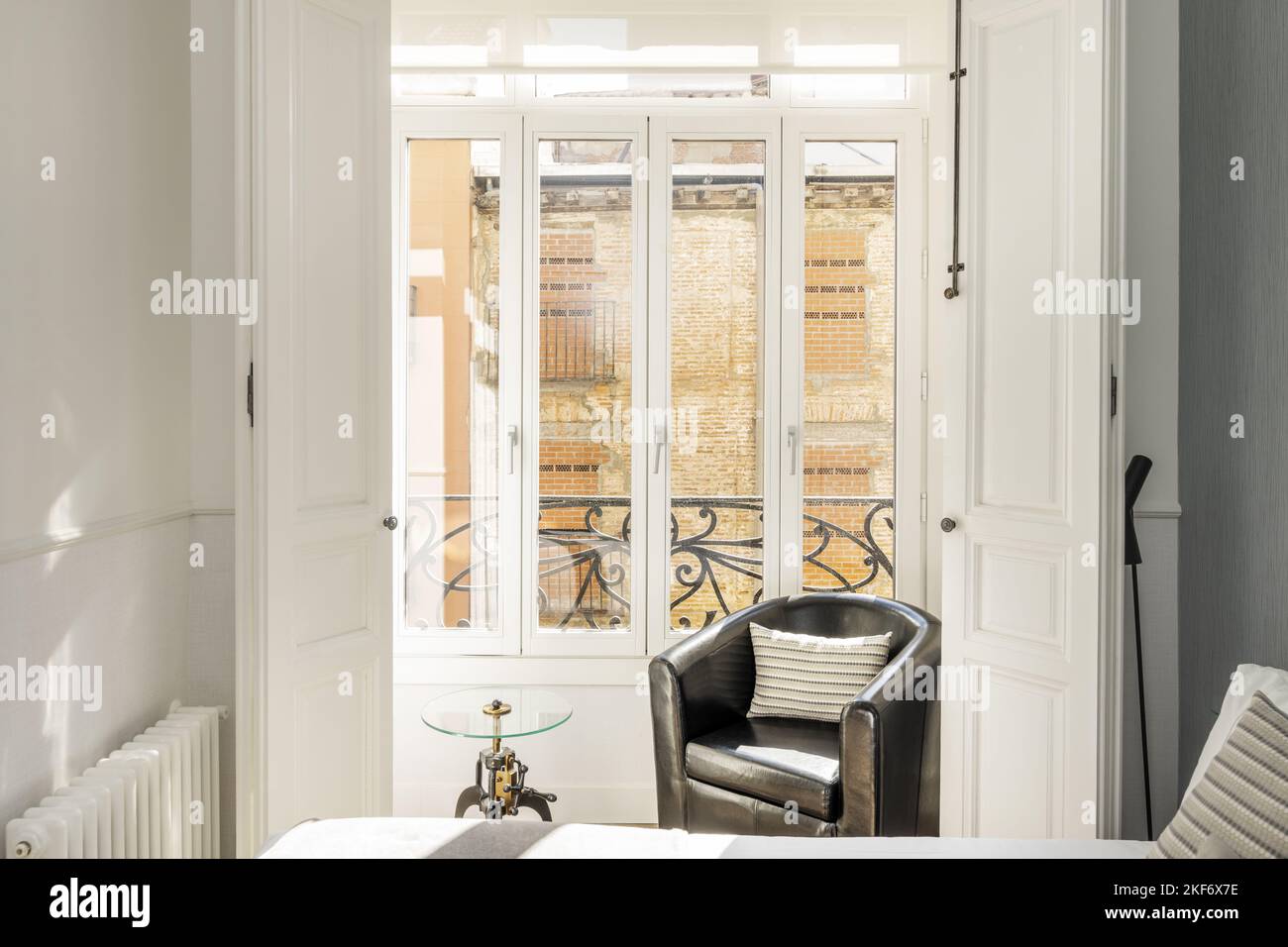 Corner of a bedroom with a reading sofa and a white bay window Stock ...