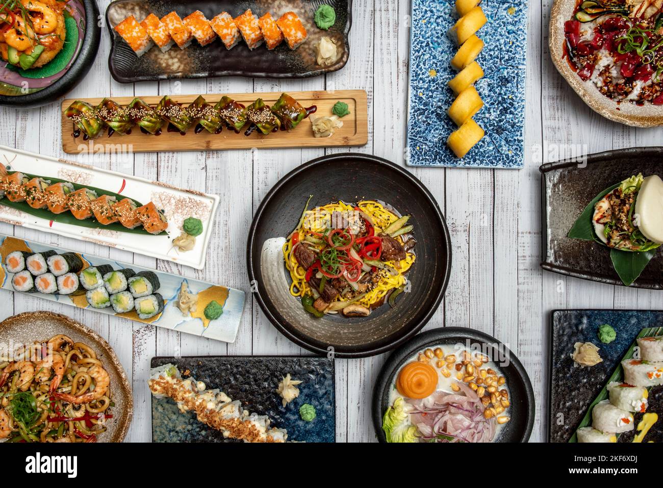 Japanese peruvian fusion food dish set with ceviches, bao bread, stew ...