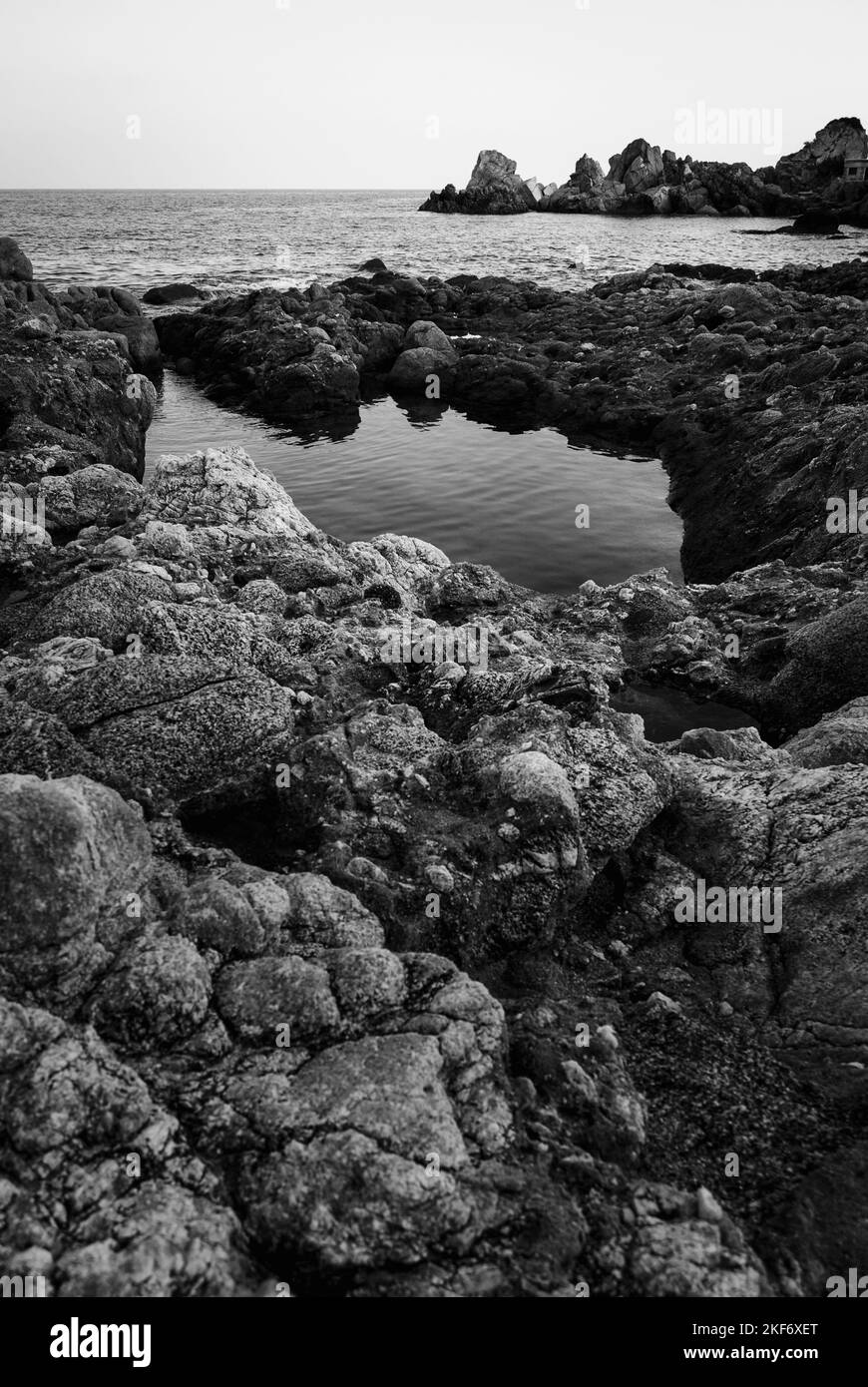 A greyscale of a river with rocks around it Stock Photo - Alamy