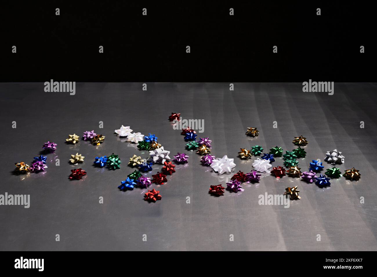 Colorful wrapping paper stars forming patterns on shiny gray texture ...