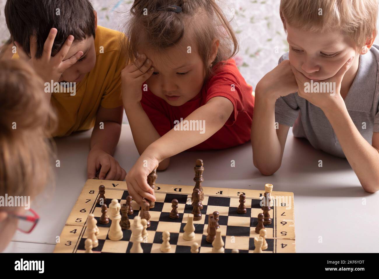Happy children are playing chess, developing game concept Stock Photo ...